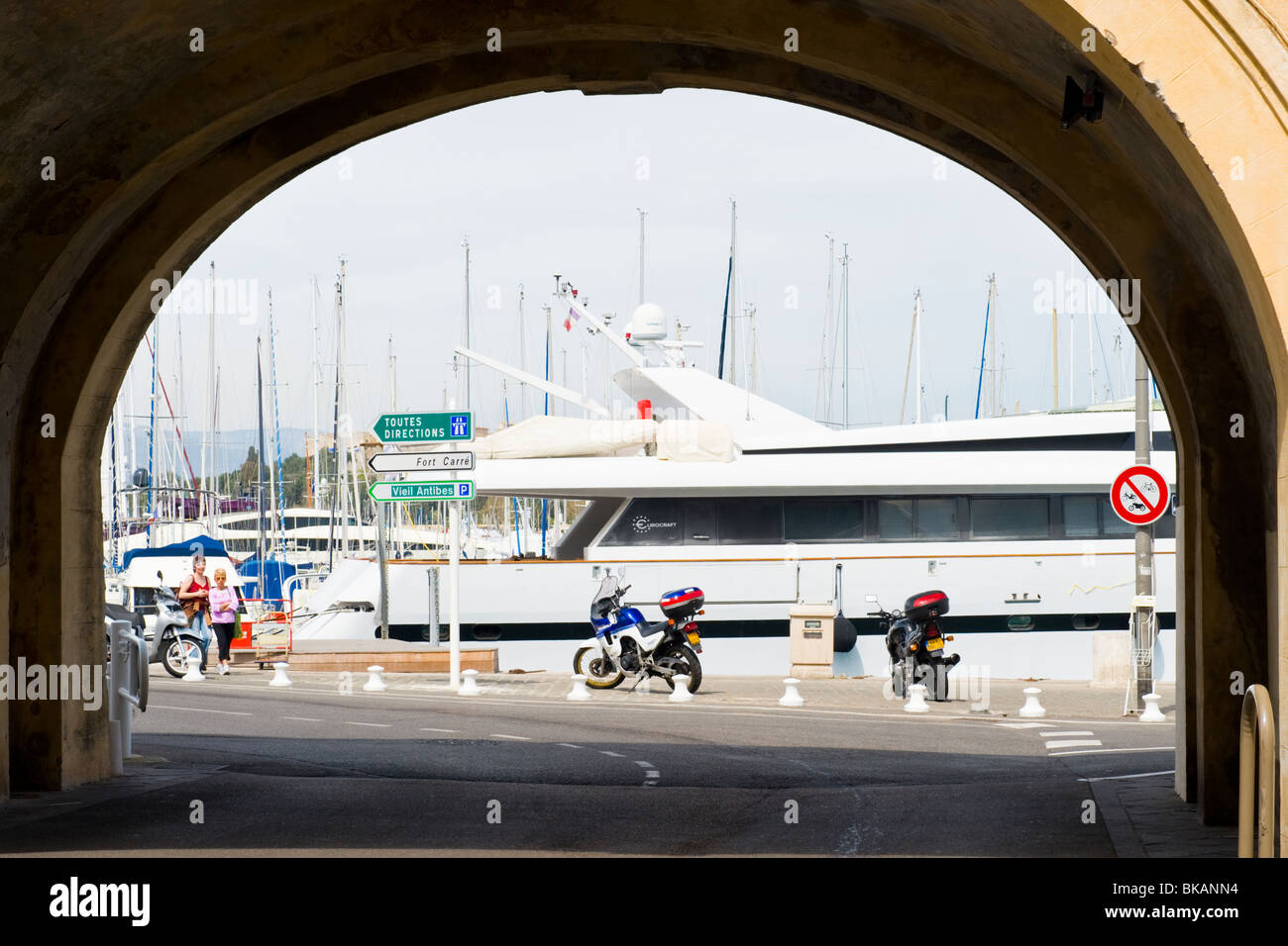 View of Antibes Marina , through arch in old town wall with massive ...