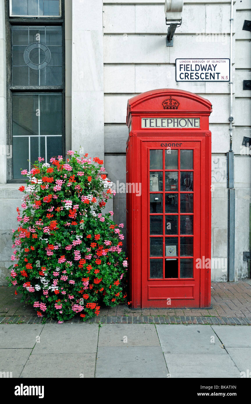 Red telephone box with flowers alongside Highbury London England UK ...