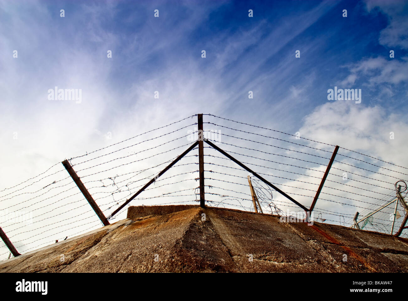Barbed wire fence top wall hi-res stock photography and images - Alamy
