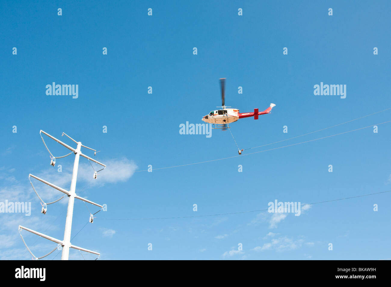 a helicopter is used to string a cable during construction of a new ...
