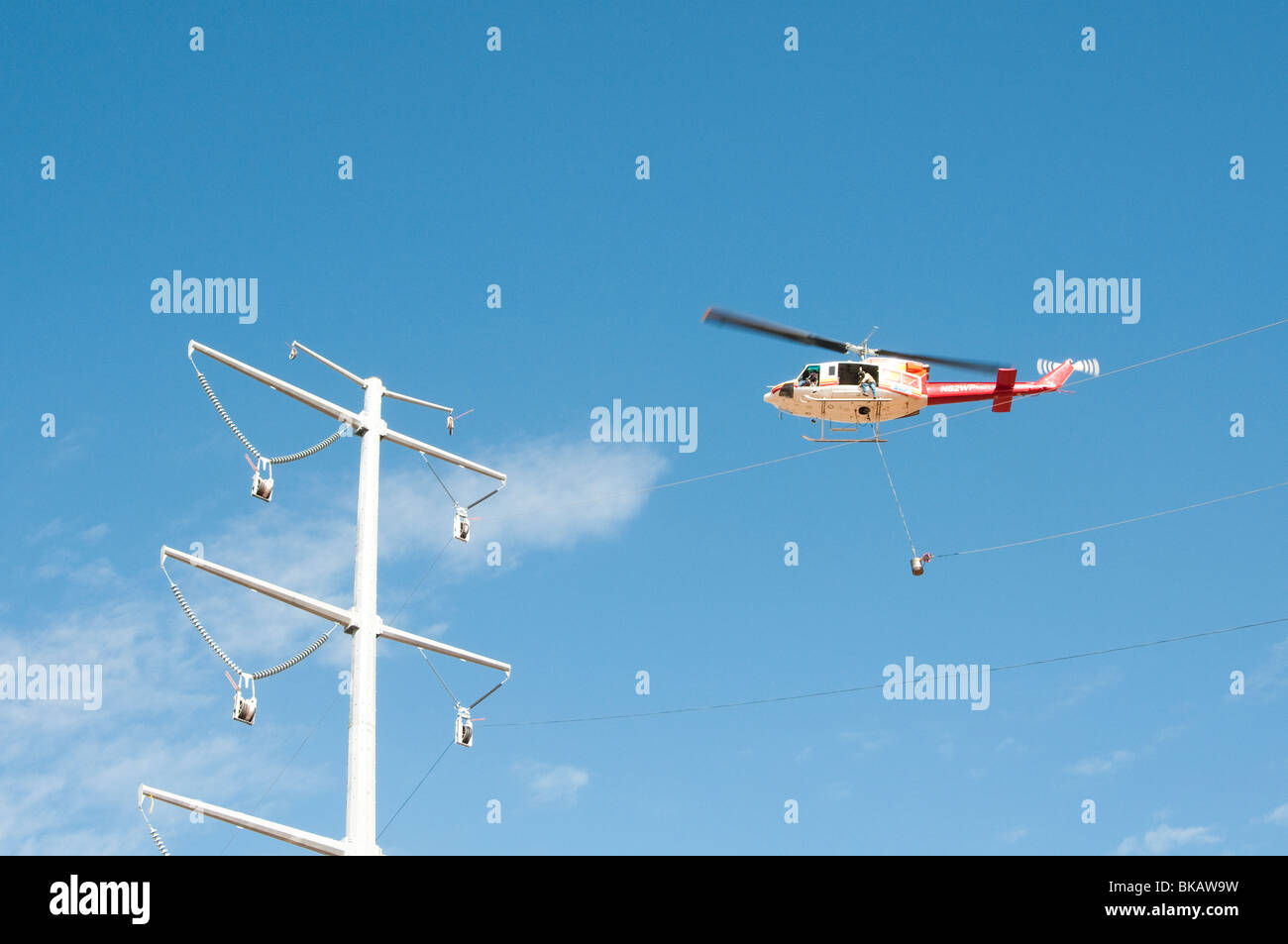 a helicopter is used to string a cable during construction of a new ...