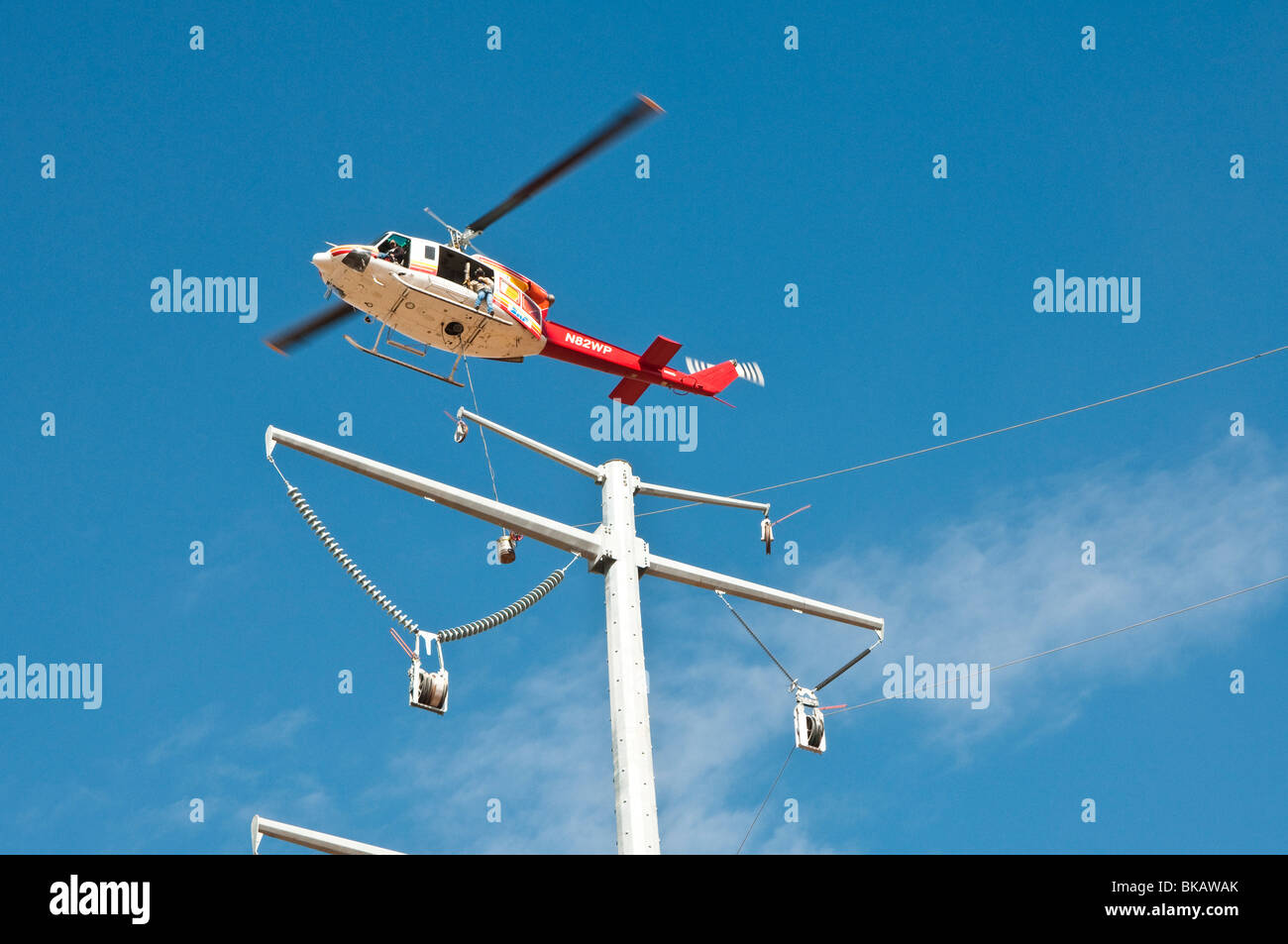 a helicopter is used to string a cable during construction of a new ...