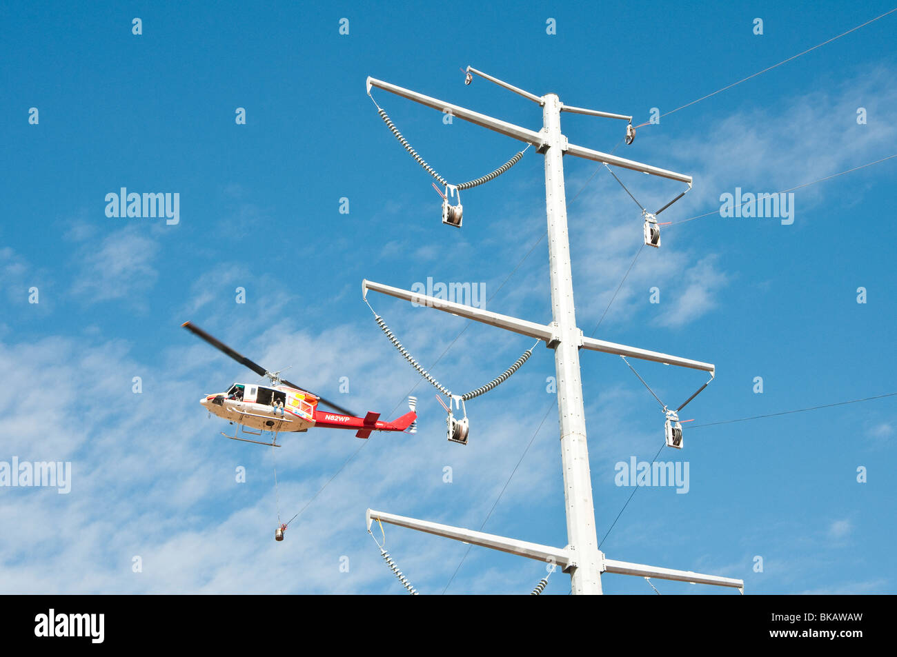 a helicopter is used to string a cable during construction of a new ...