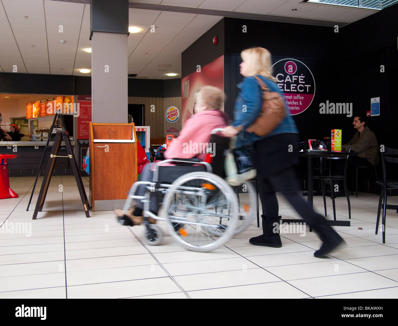 Woman Pushing Older Woman in Wheelchair Stock Photo - Alamy