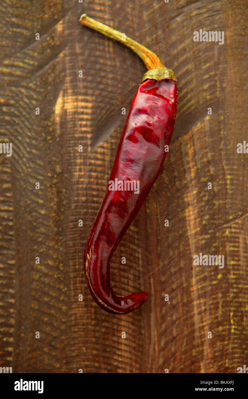 Red dried hot chili pepper over a dark wood background Stock Photo - Alamy