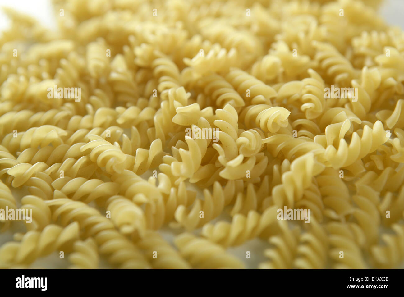 Close-up of italian spiral yellow pasta texture as background Stock ...