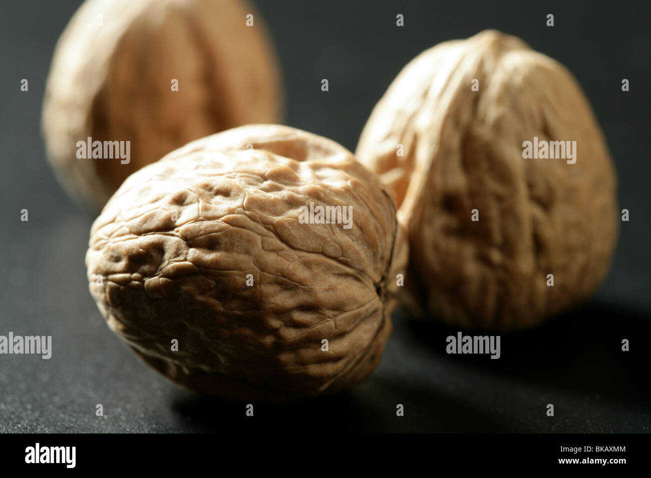 Three walnuts with shells over black background and shadows Stock Photo ...