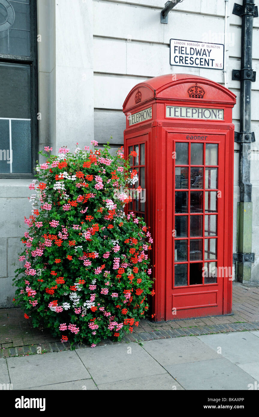 Red telephone box with flowers alongside Highbury London England UK ...
