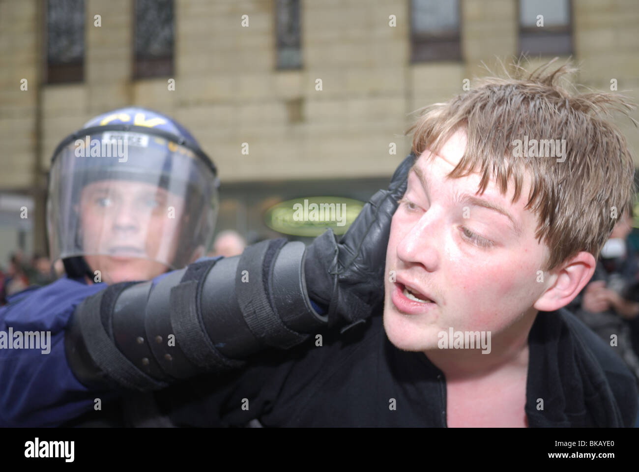 A Unite Against Fascism supporter is arrested by riot police at an ...
