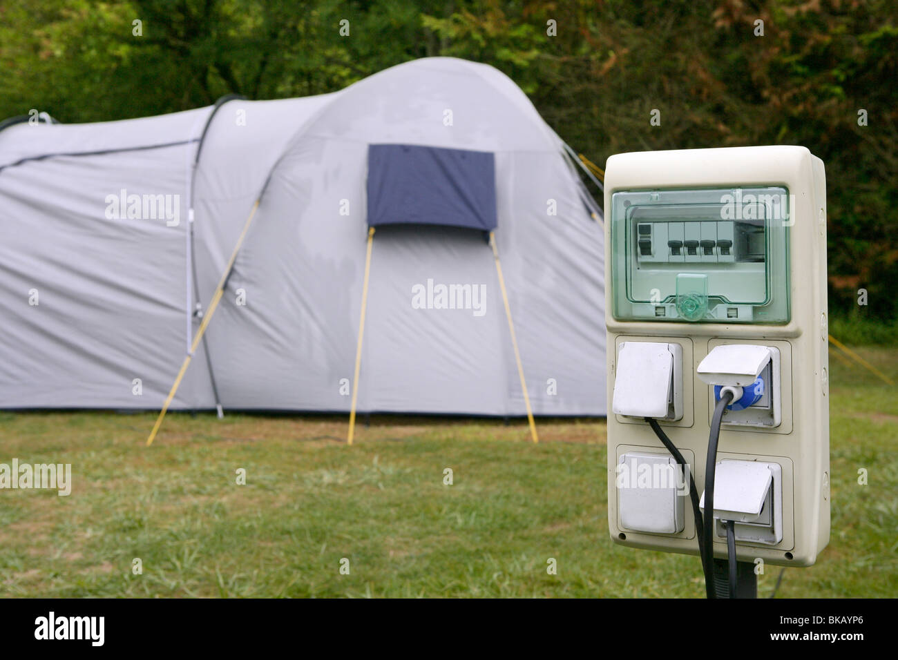 Electric camping plug box detail with tent in background Stock Photo ...