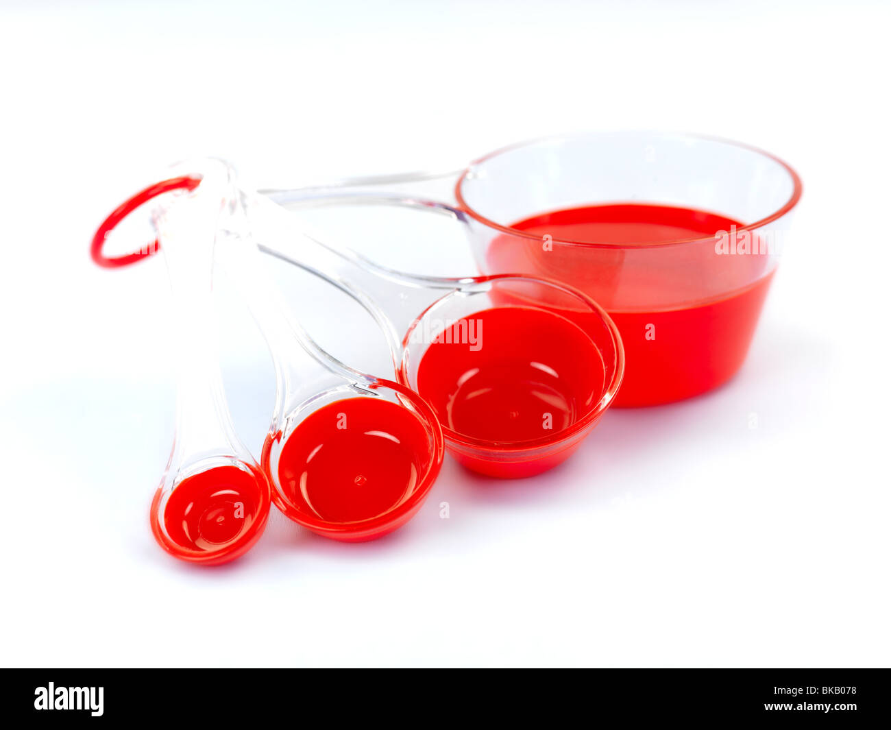 Measuring cups isolated against a blue background Stock Photo - Alamy