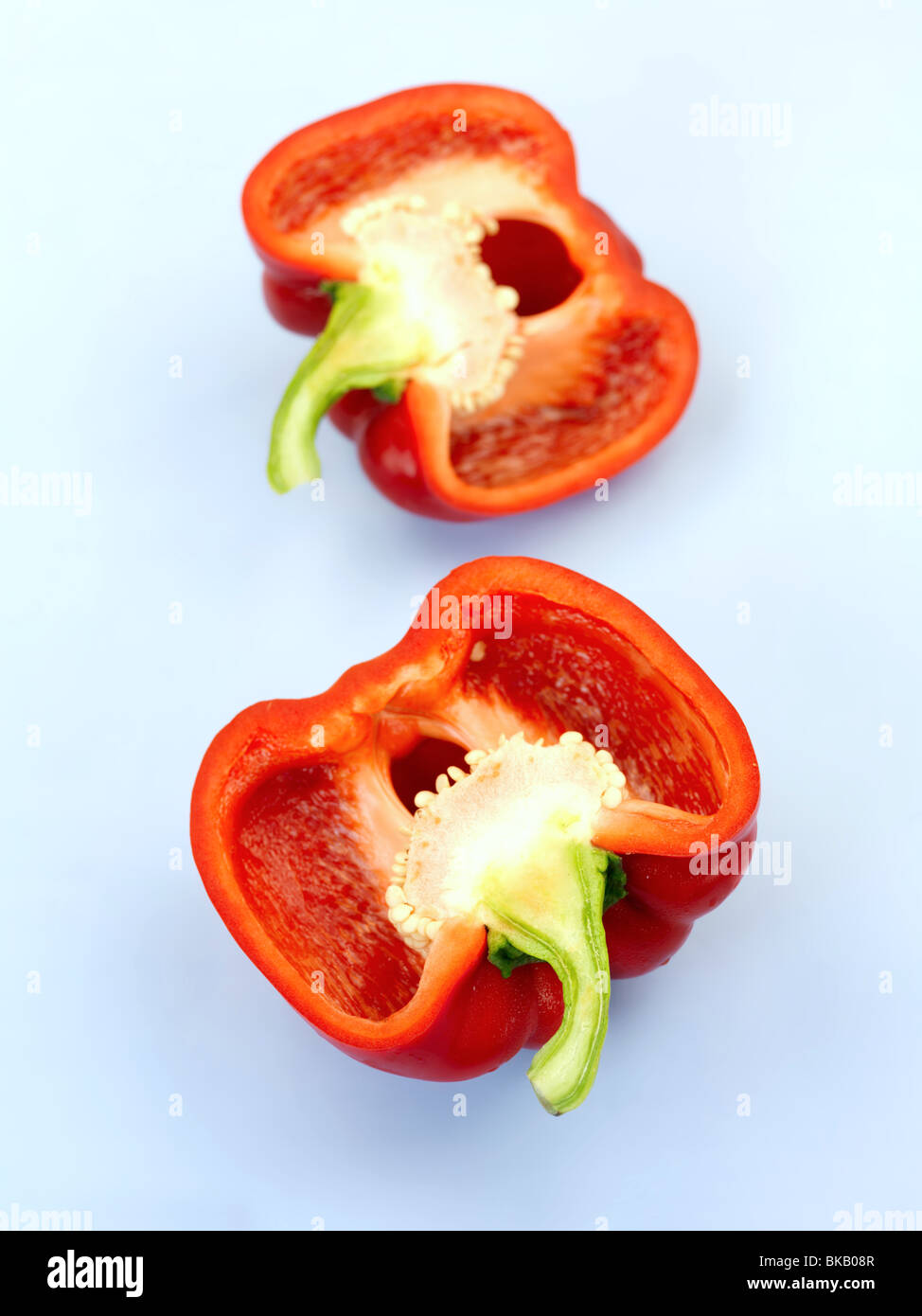 A red capsicum isolated against a blue background Stock Photo - Alamy