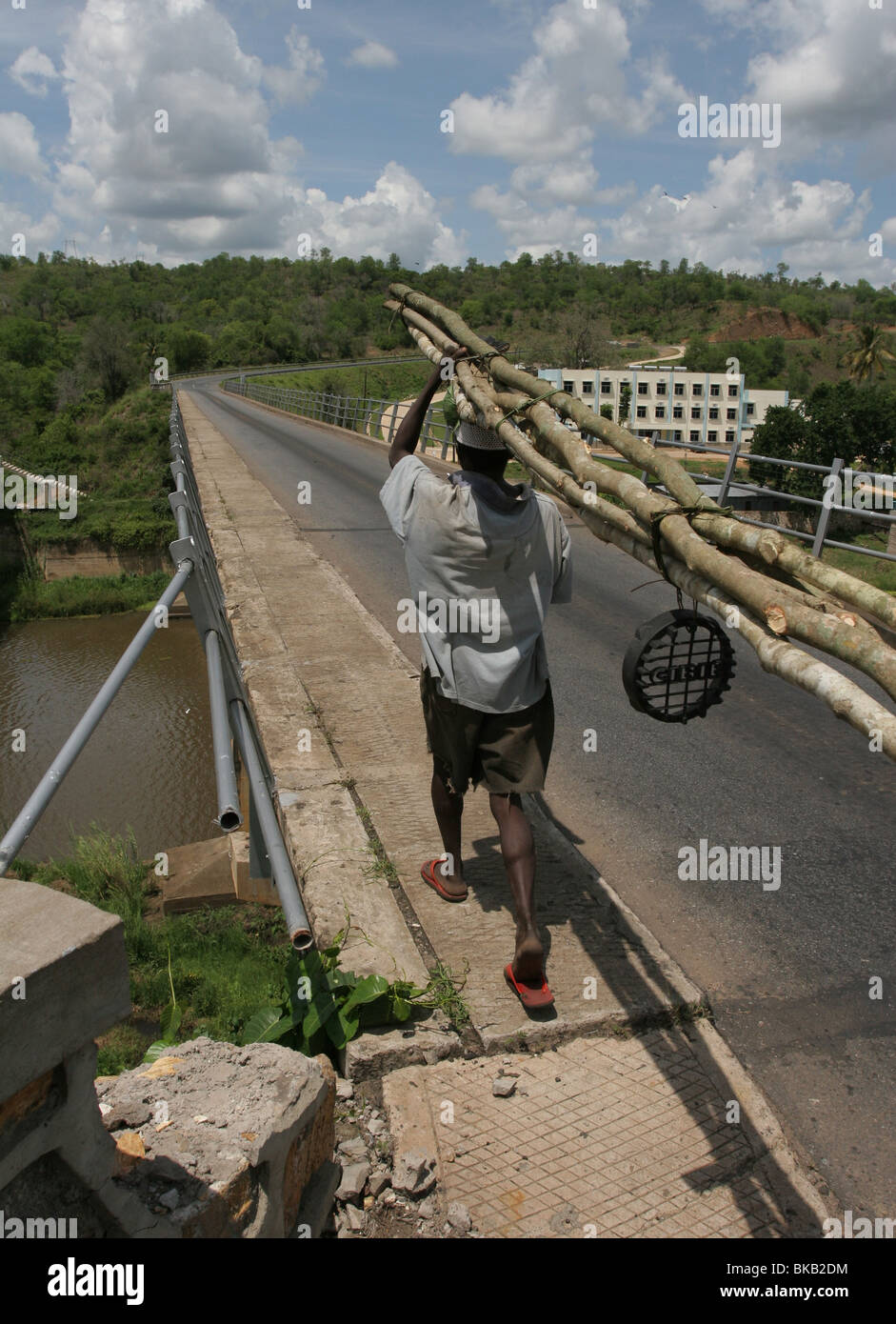 man carrying firewood bridge Tanzania Stock Photo - Alamy