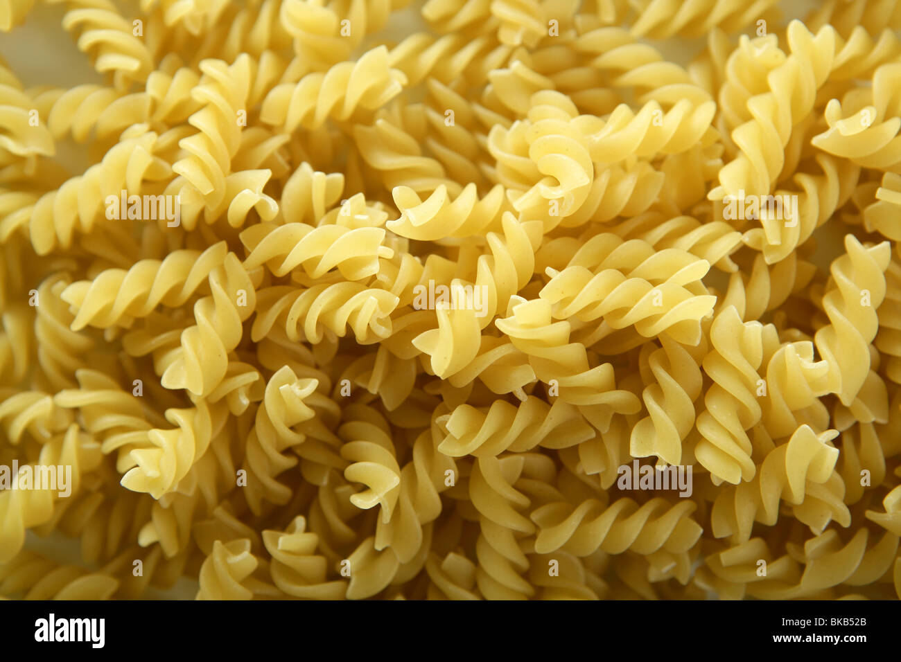Close-up of italian spiral yellow pasta texture as background Stock ...