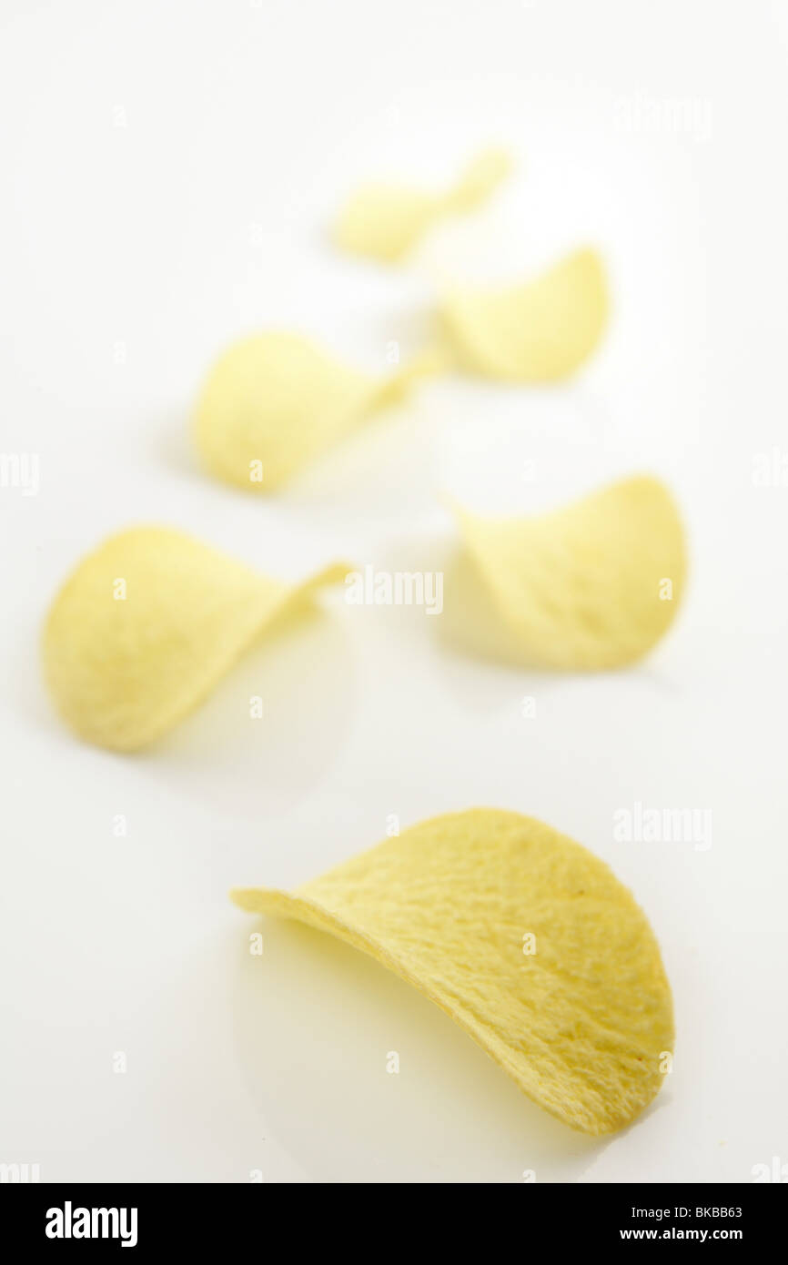 Potato salted chips slices over white background Stock Photo - Alamy