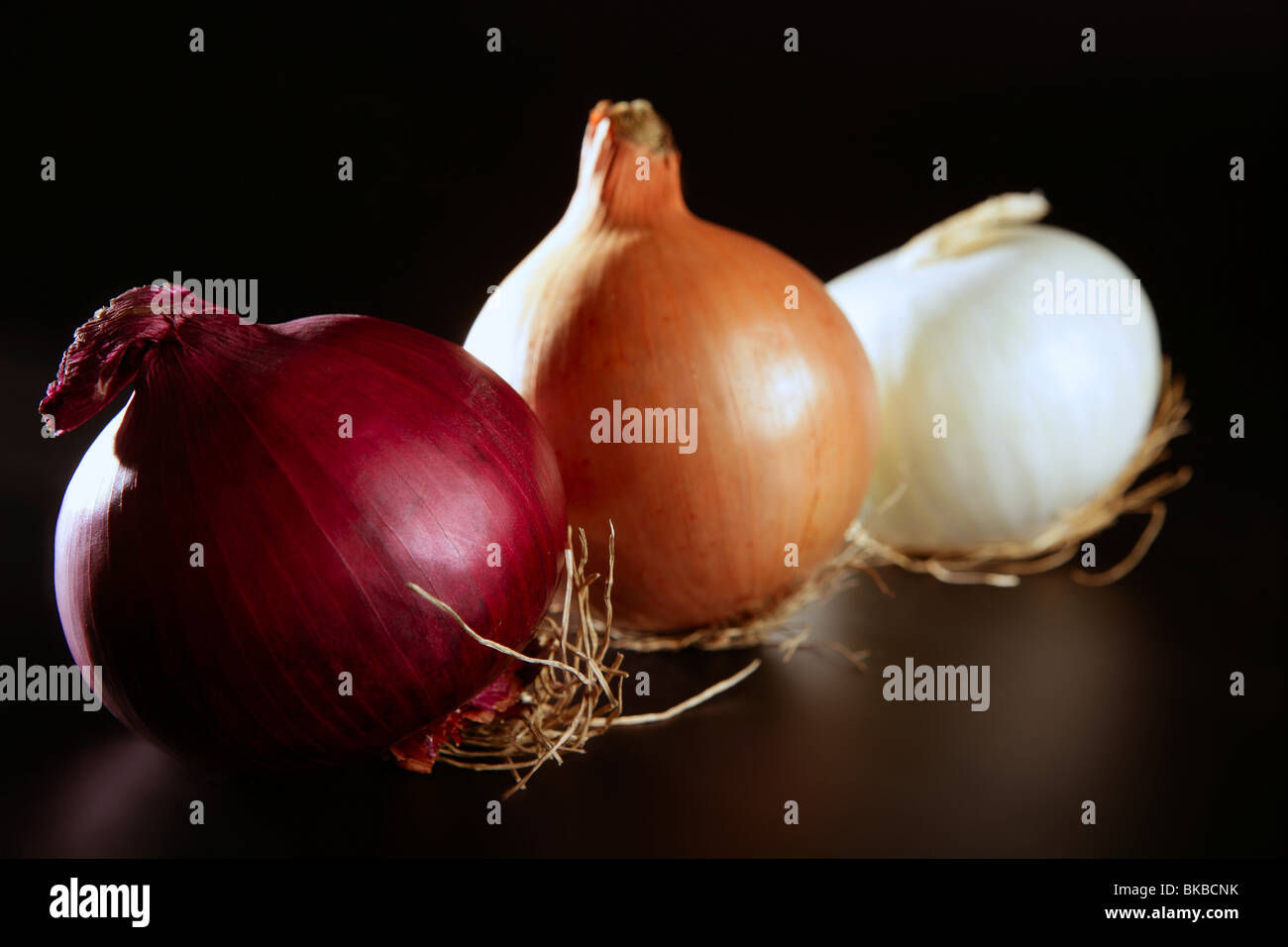 Three colorful different onion in varied colors over black Stock Photo ...