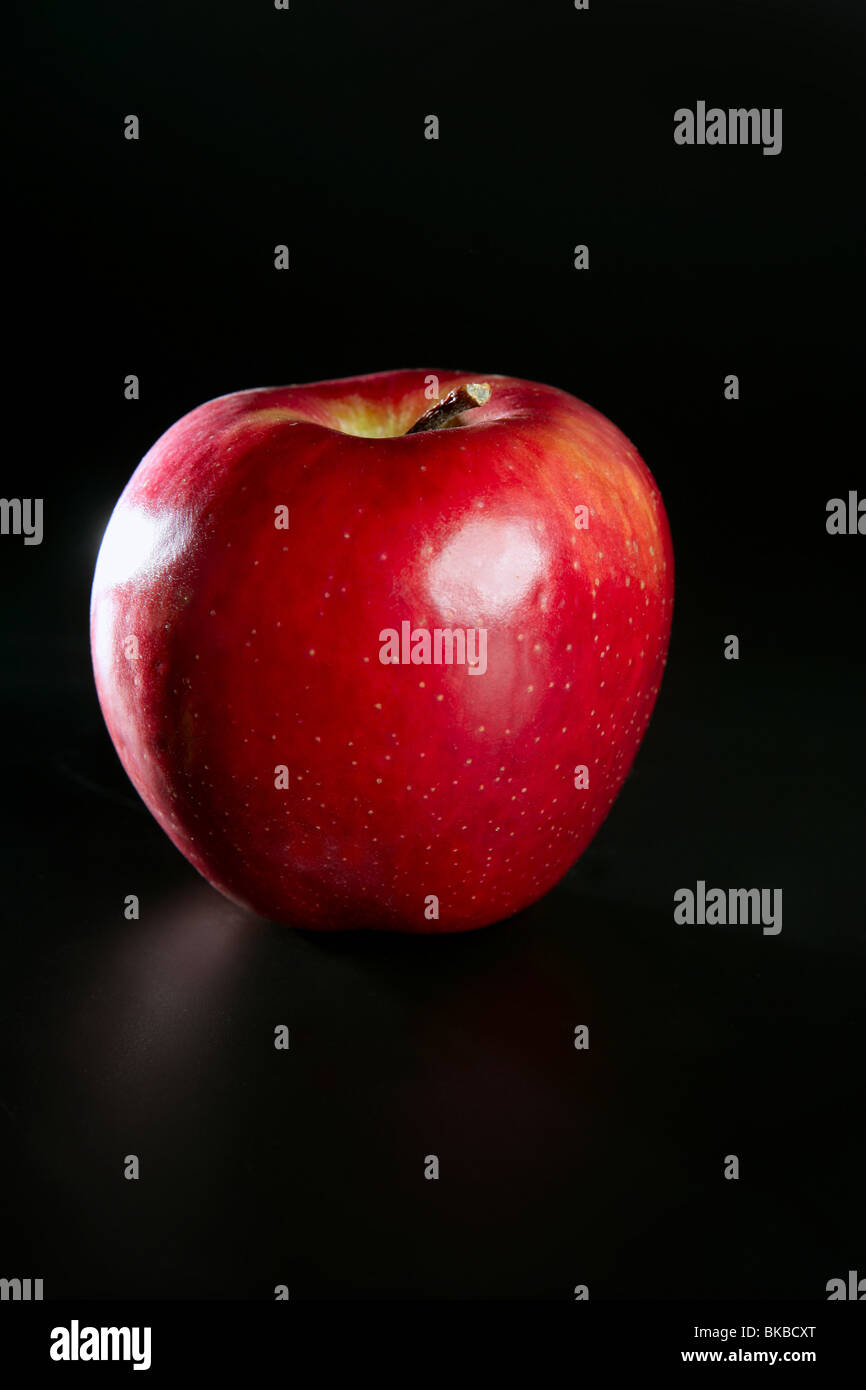 Apple red fruit isolated over black background Stock Photo - Alamy