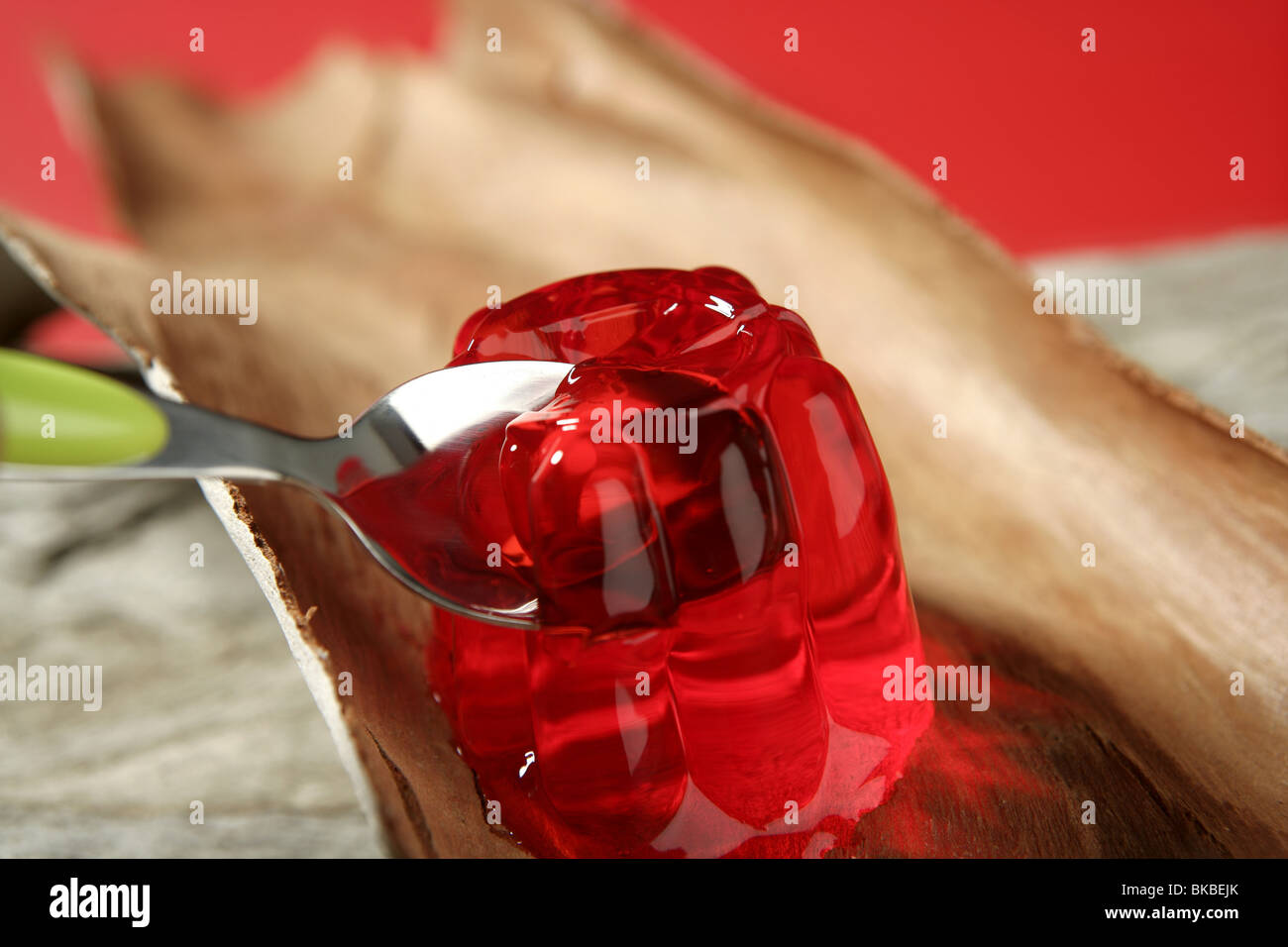 Jelly in red strawberry color in green spoon over wood Stock Photo - Alamy