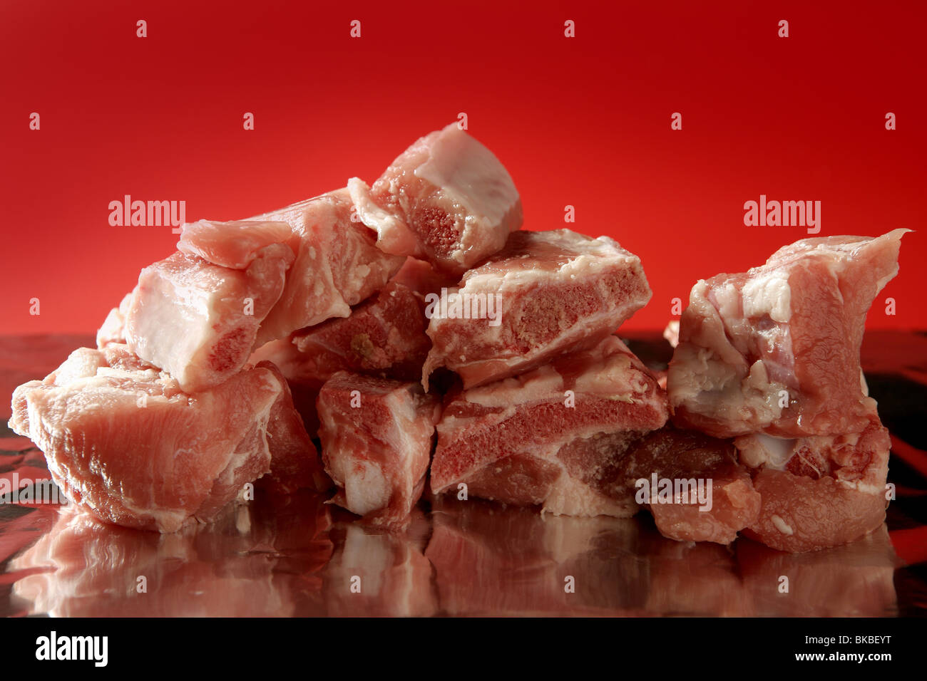 Pig, pork raw meat pieces over red background Stock Photo - Alamy