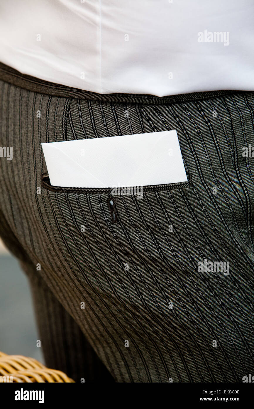 The picture depicts a piece of paper sticking out of the back pocket of ...