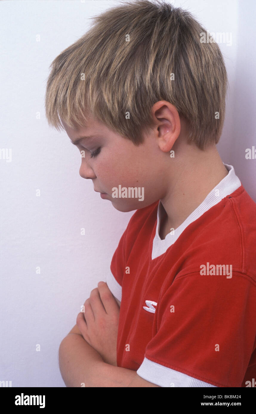 sulky looking boy with arms folded Stock Photo - Alamy