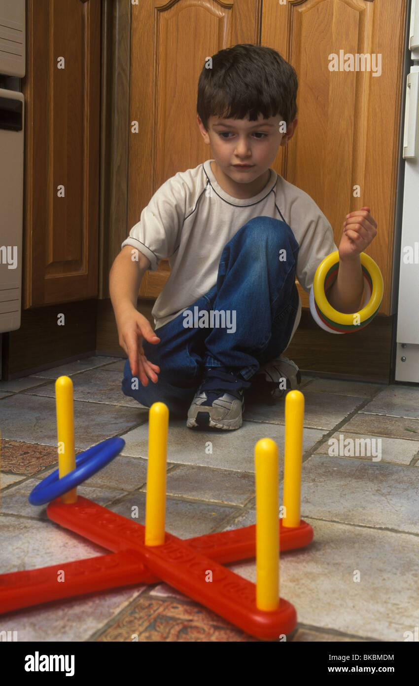 boy playing with quoits in the kitchen Stock Photo - Alamy