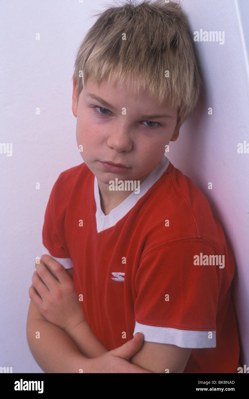 sulky looking boy with arms folded Stock Photo - Alamy