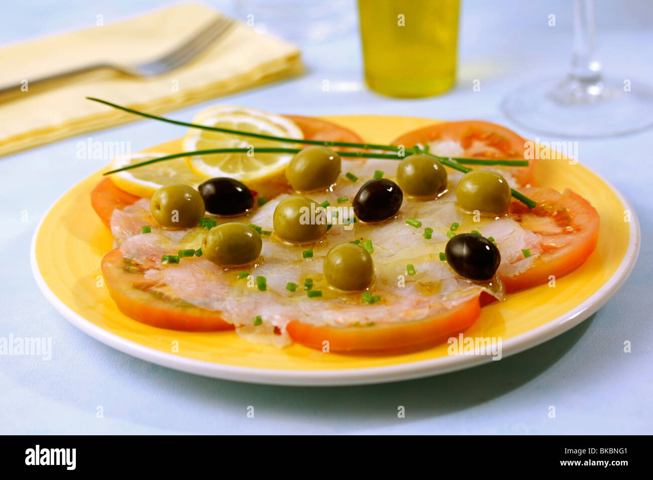 Cod fish carpaccio on tomato. Recipe available Stock Photo - Alamy