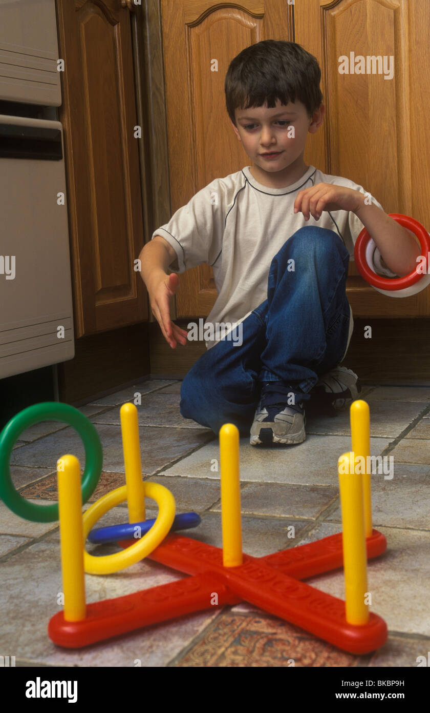 boy playing with quoits in the kitchen Stock Photo - Alamy