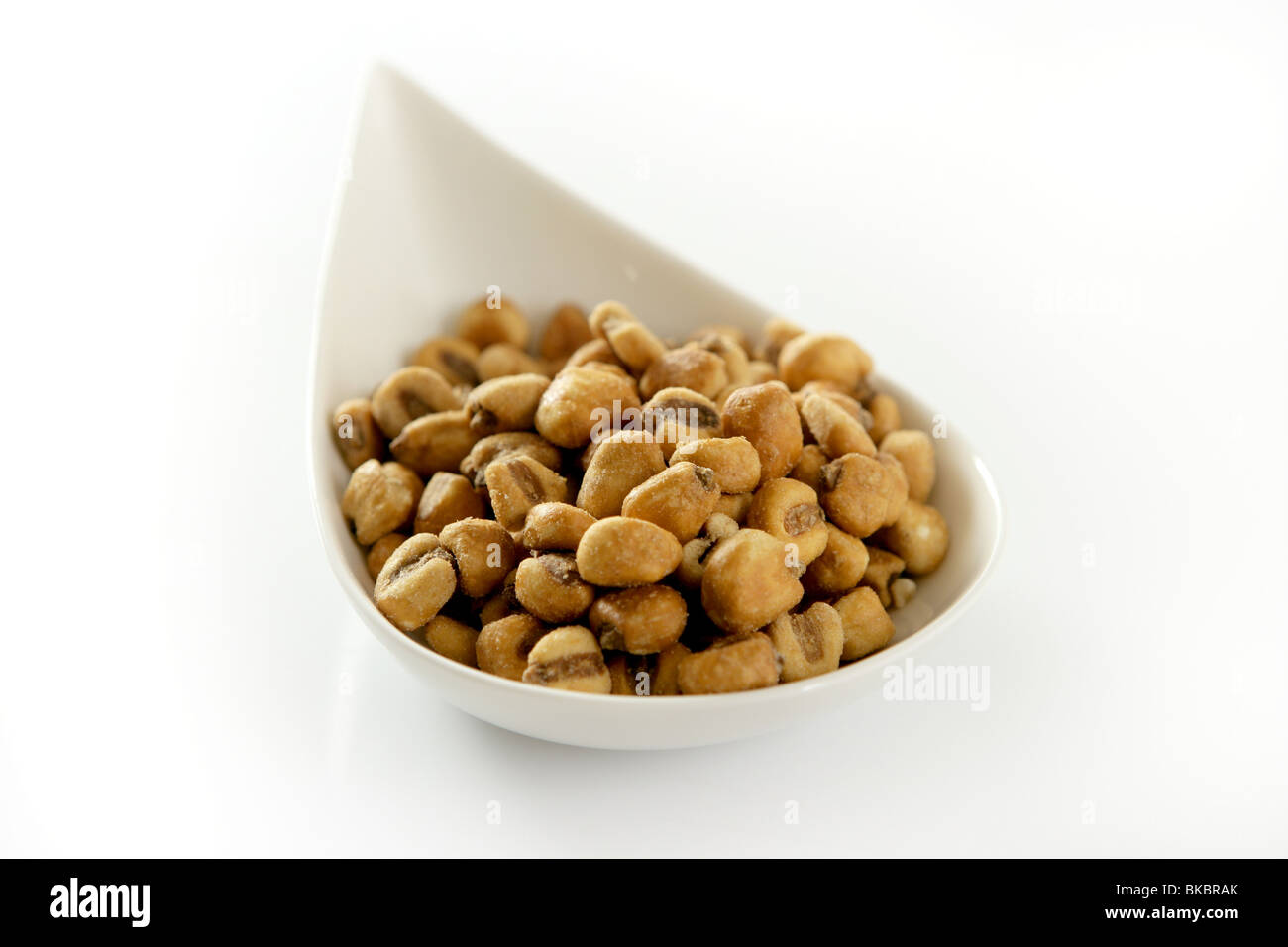 Roasted salted corn in a white bowl, white background studio shoot ...