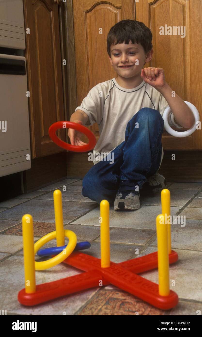 boy playing with quoits in the kitchen Stock Photo - Alamy