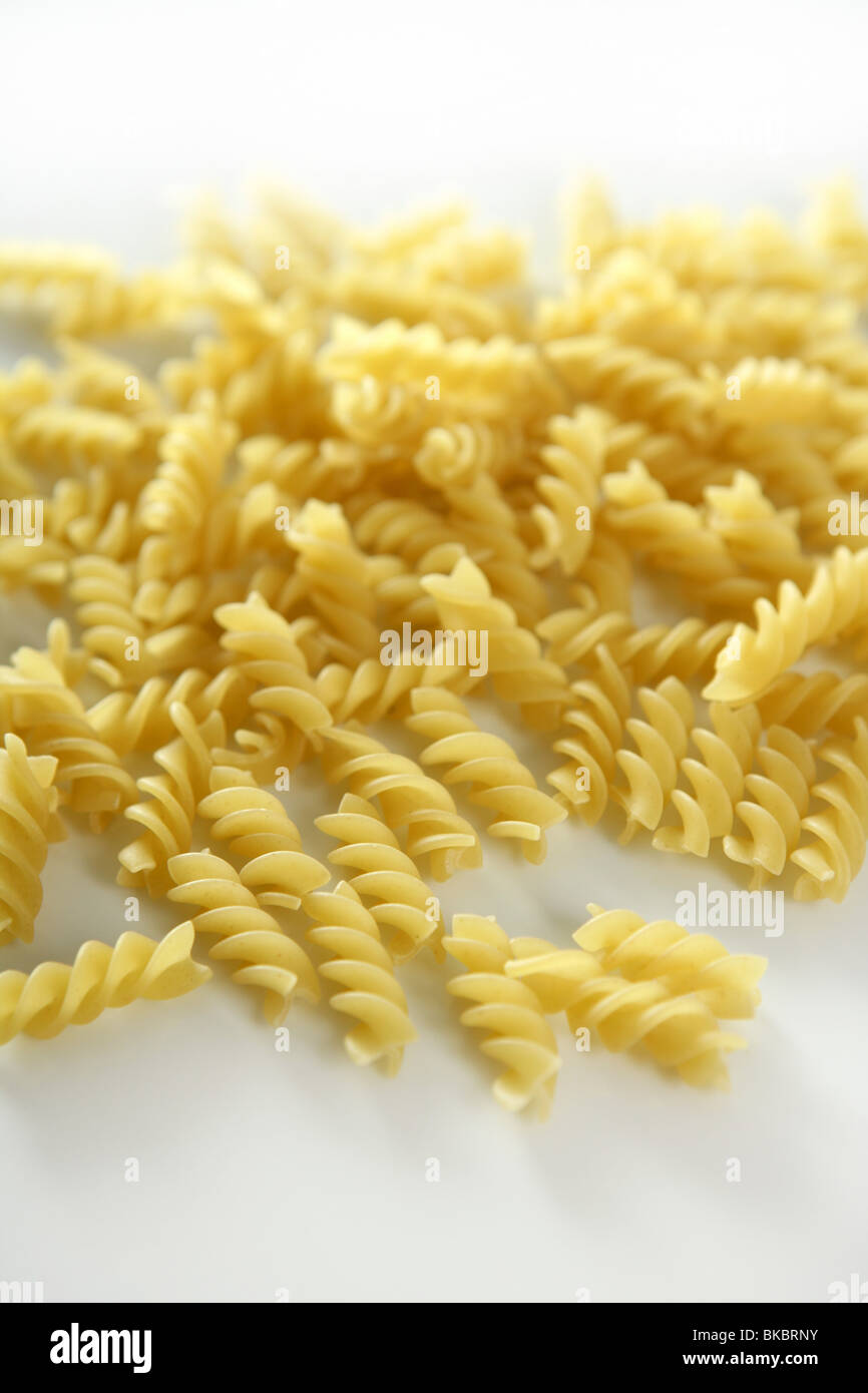 Italian spiral pasta texture with selective focus, white studio ...