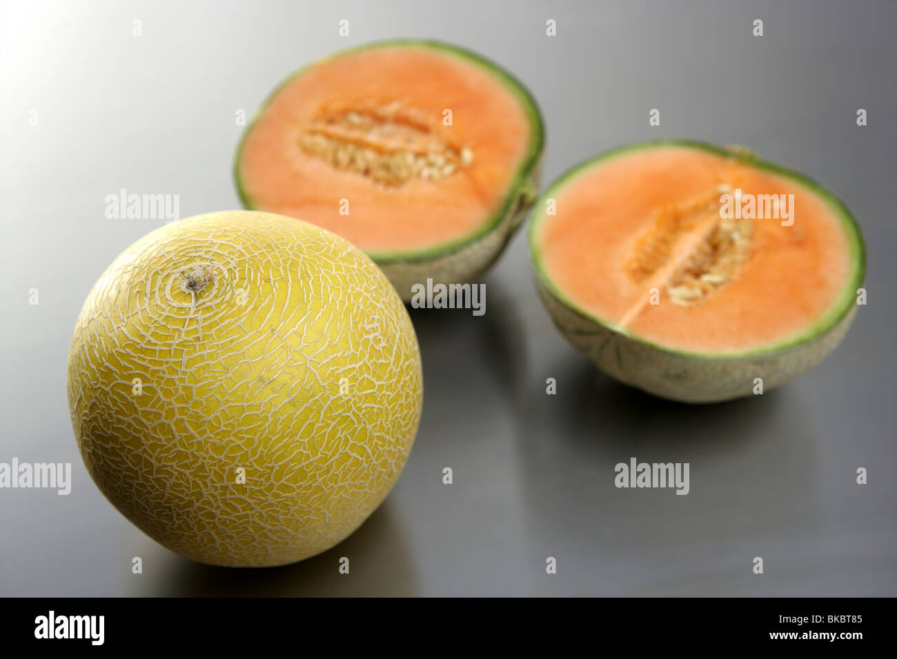 Two melon fruit over a stainless steel table Stock Photo - Alamy