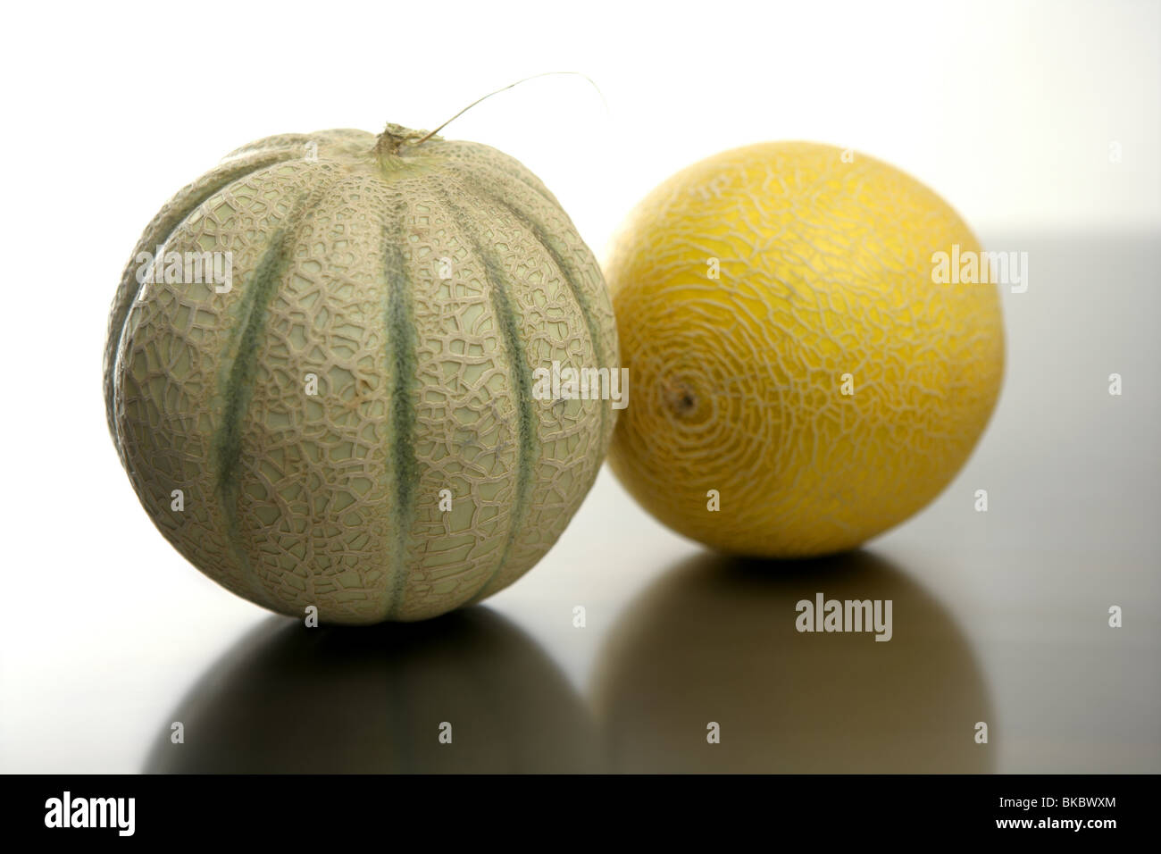 Two melon fruit over a stainless steel table Stock Photo - Alamy