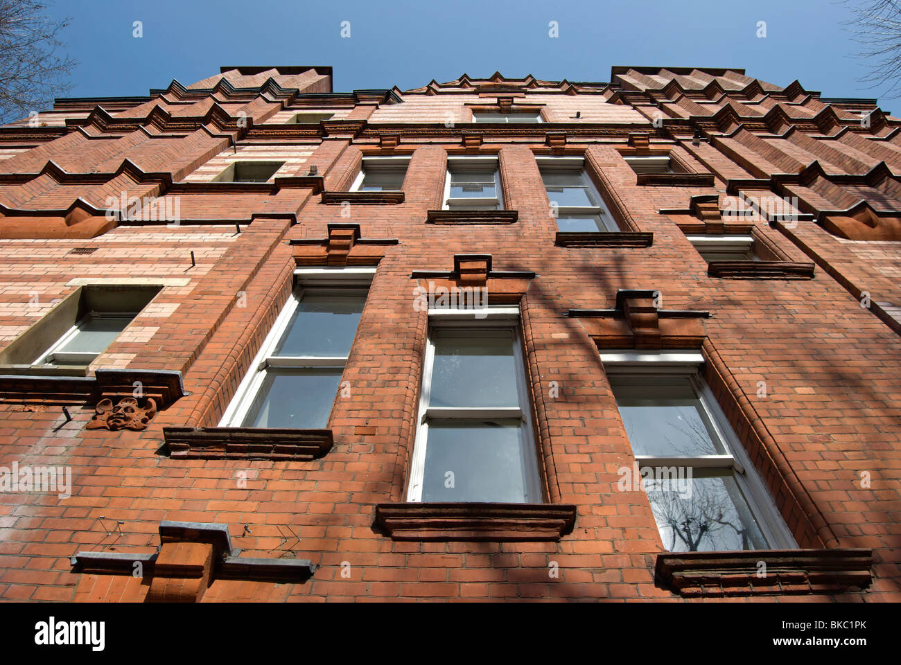 windows lining an interior staircase on a late-1800s redbrick apartment ...