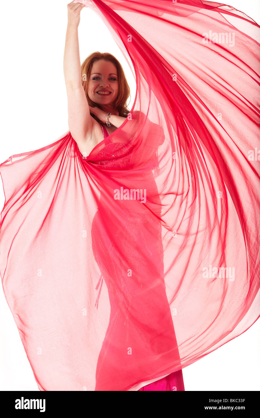 Lithe adult caucasian belly dancer with red hair and pink belly dancing ...