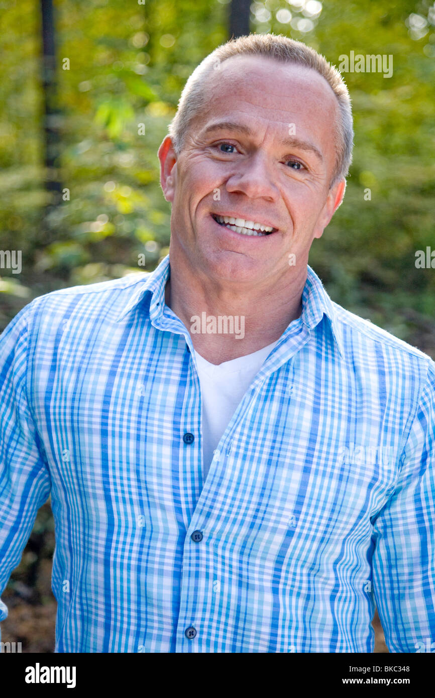 Older Man Walking in Woods Stock Photo - Alamy