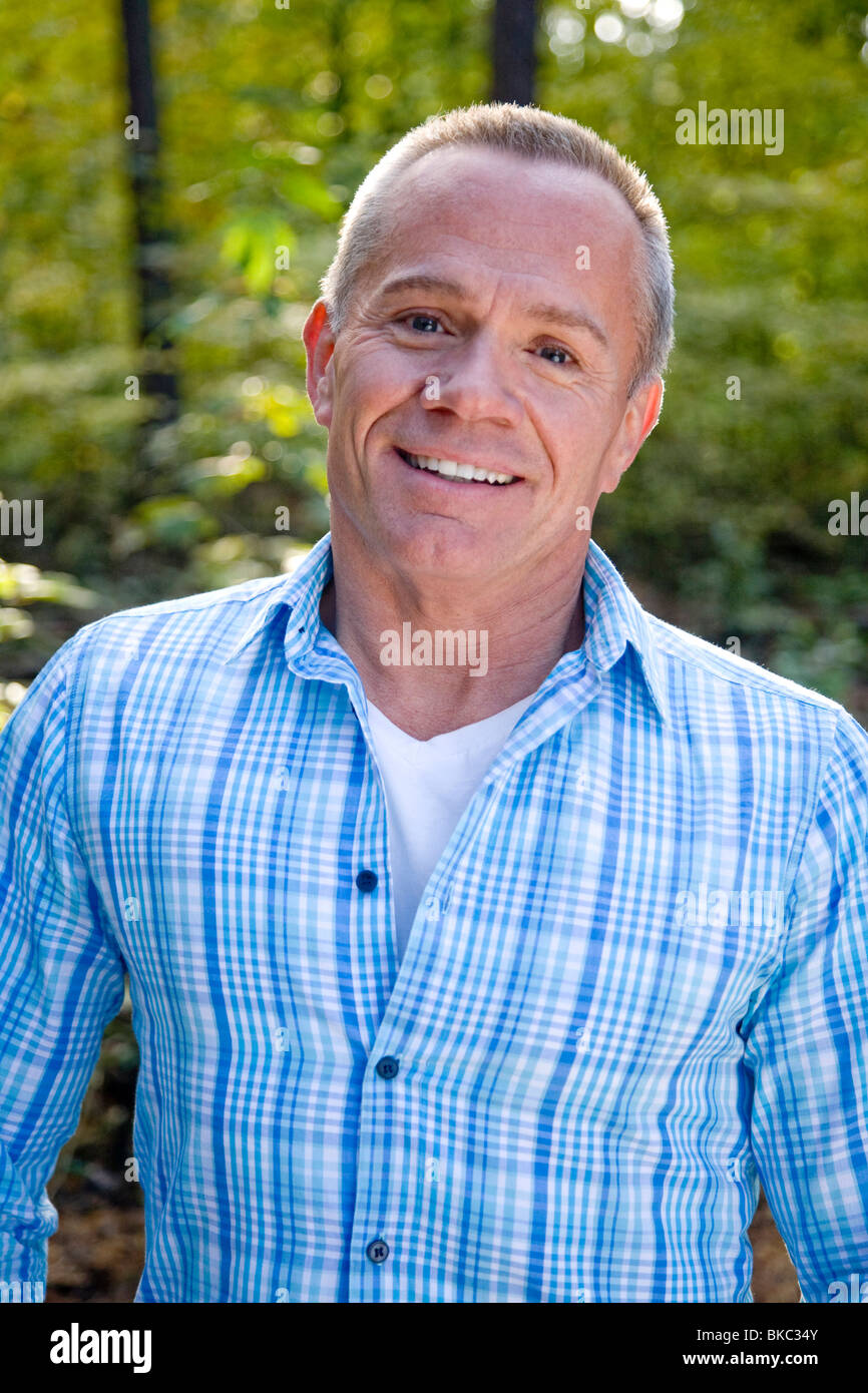 Older Man Walking in Woods Stock Photo - Alamy