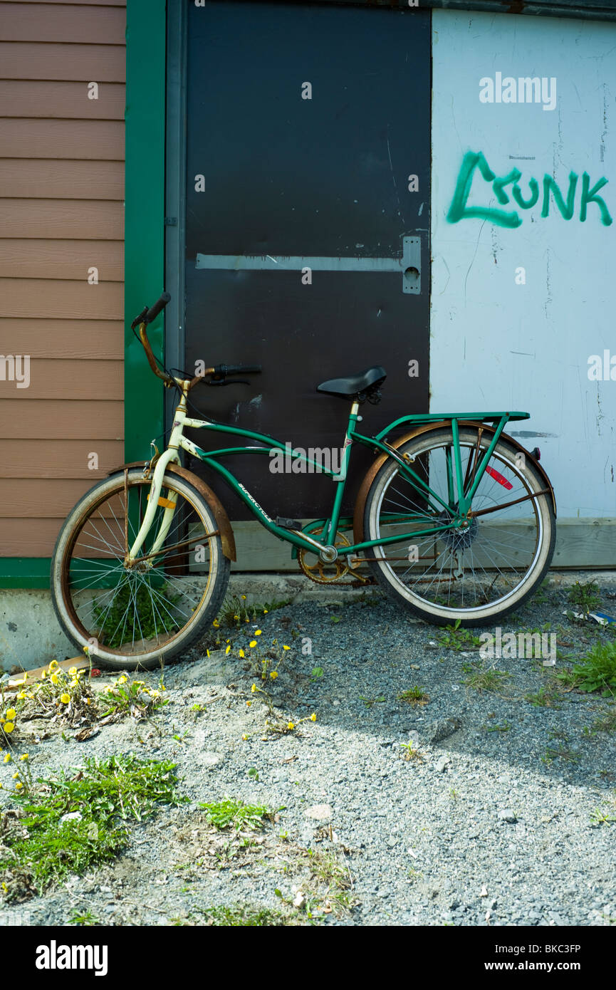 Decrepit bicycle leans against rough, graffitied shed Stock Photo - Alamy