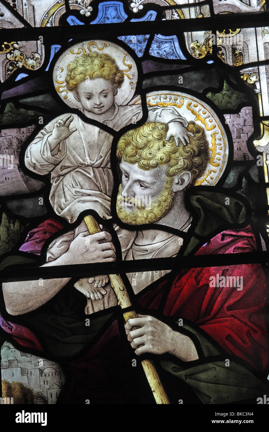 A stained glass window depicting St Christopher carrying the infant ...