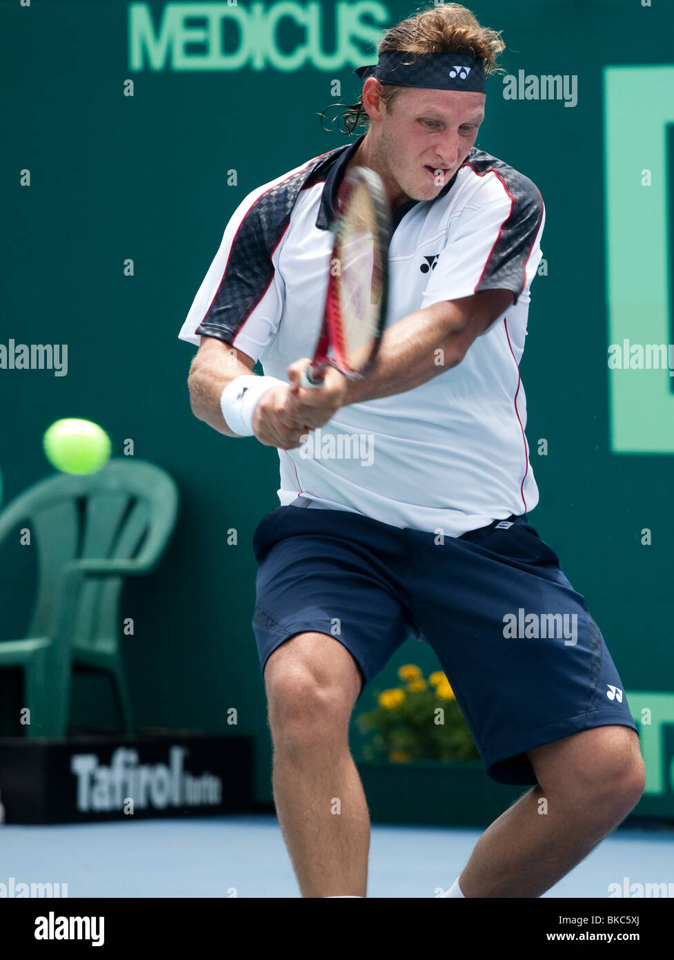 Argentinian tennis player David Nalbandian hitting a backhand shot ...