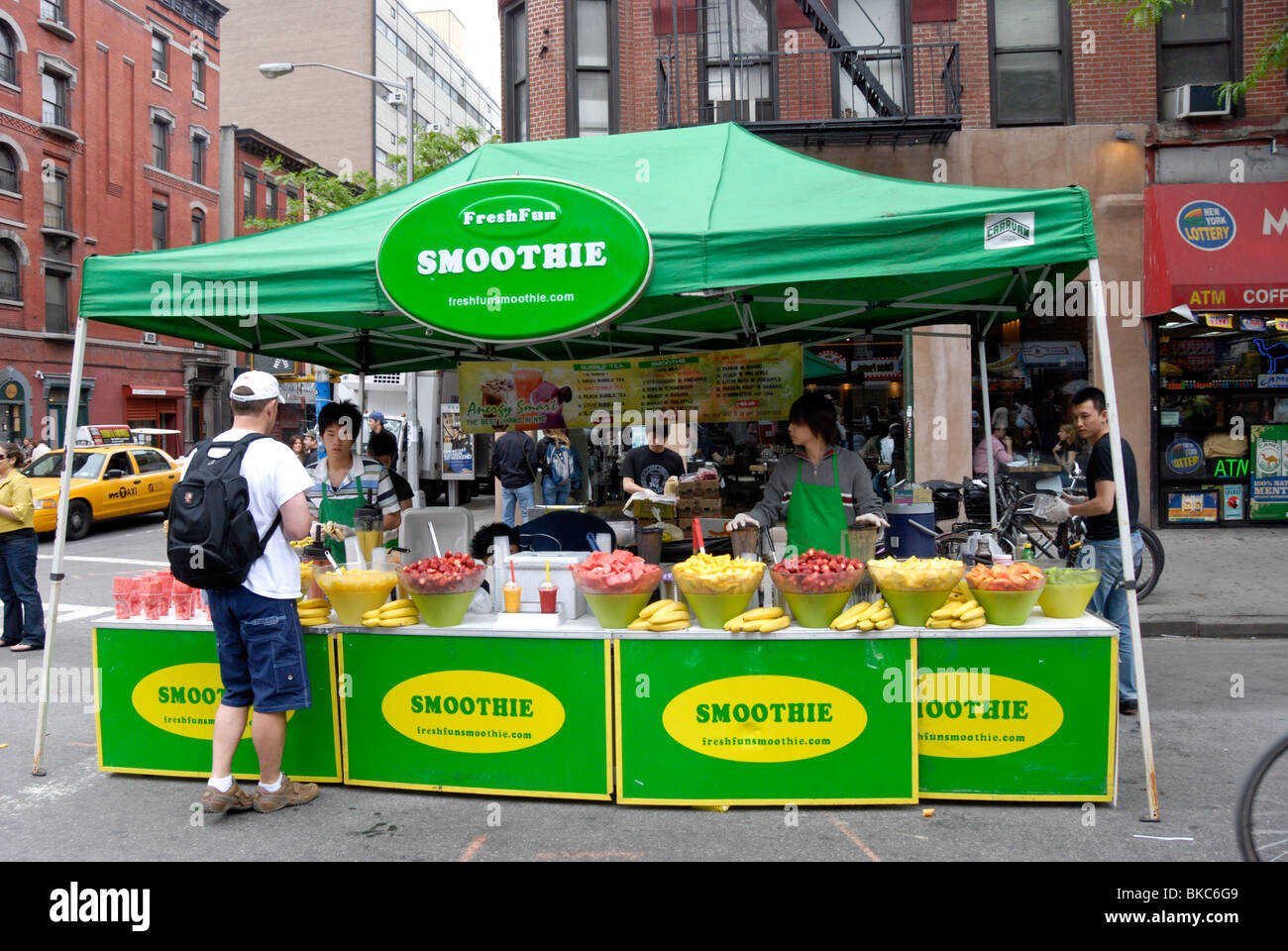 bowls of healthy fruit garnish smoothie stand run by Chinese teens at ...