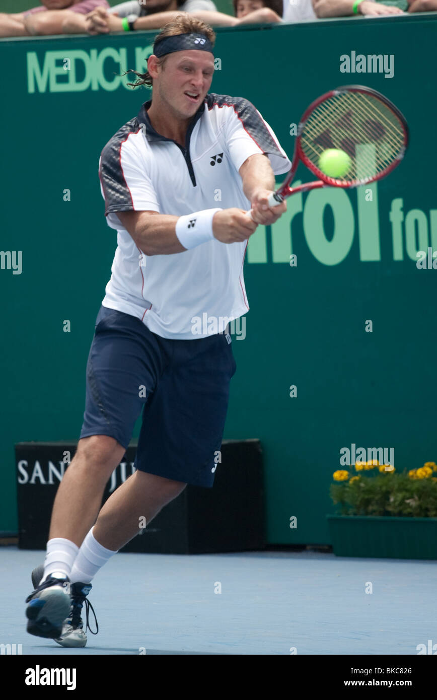 Argentinian tennis player David Nalbandian hitting a backhand shot ...