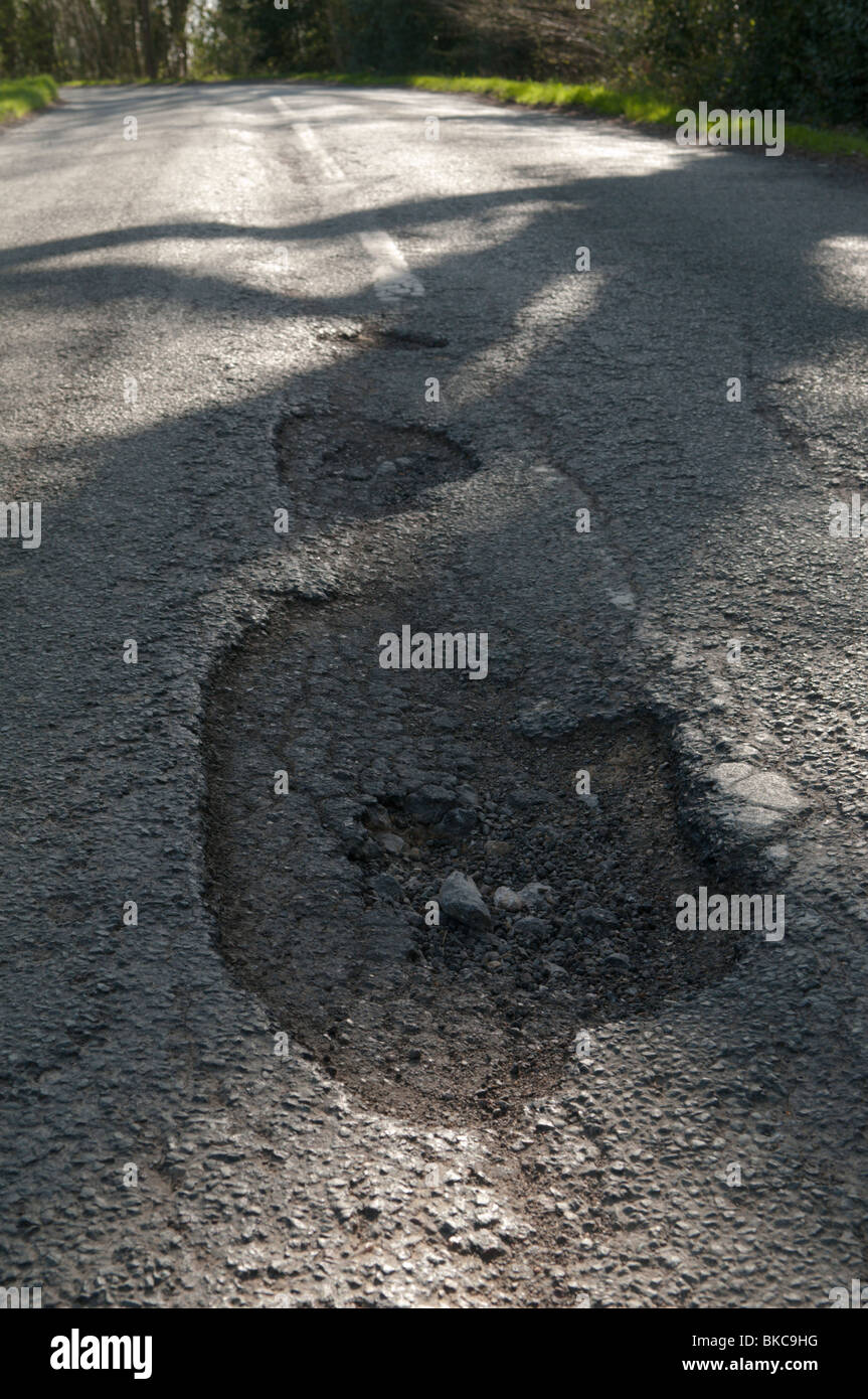 potholes in road in Sussex. Damage caused by harsh winter weather Stock ...