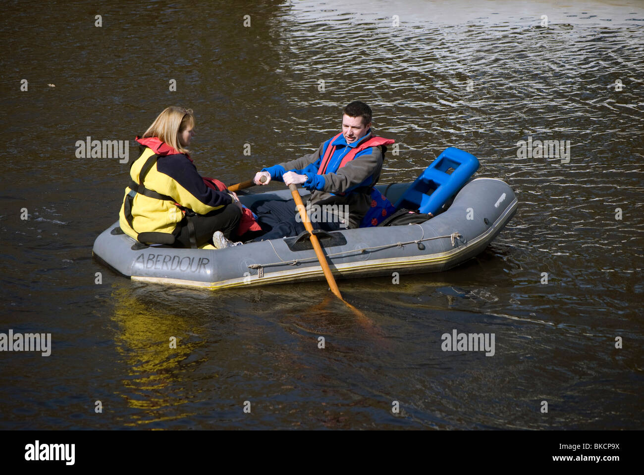 Two people in a rubber dingy at the mouth of the River Almond at ...