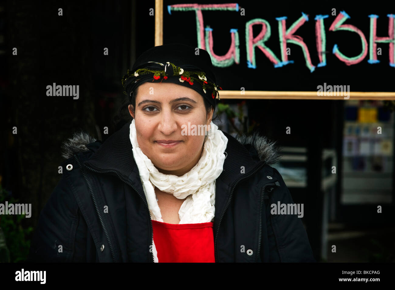 A Turkish young lady stallholder at her market stall in Camden market ...