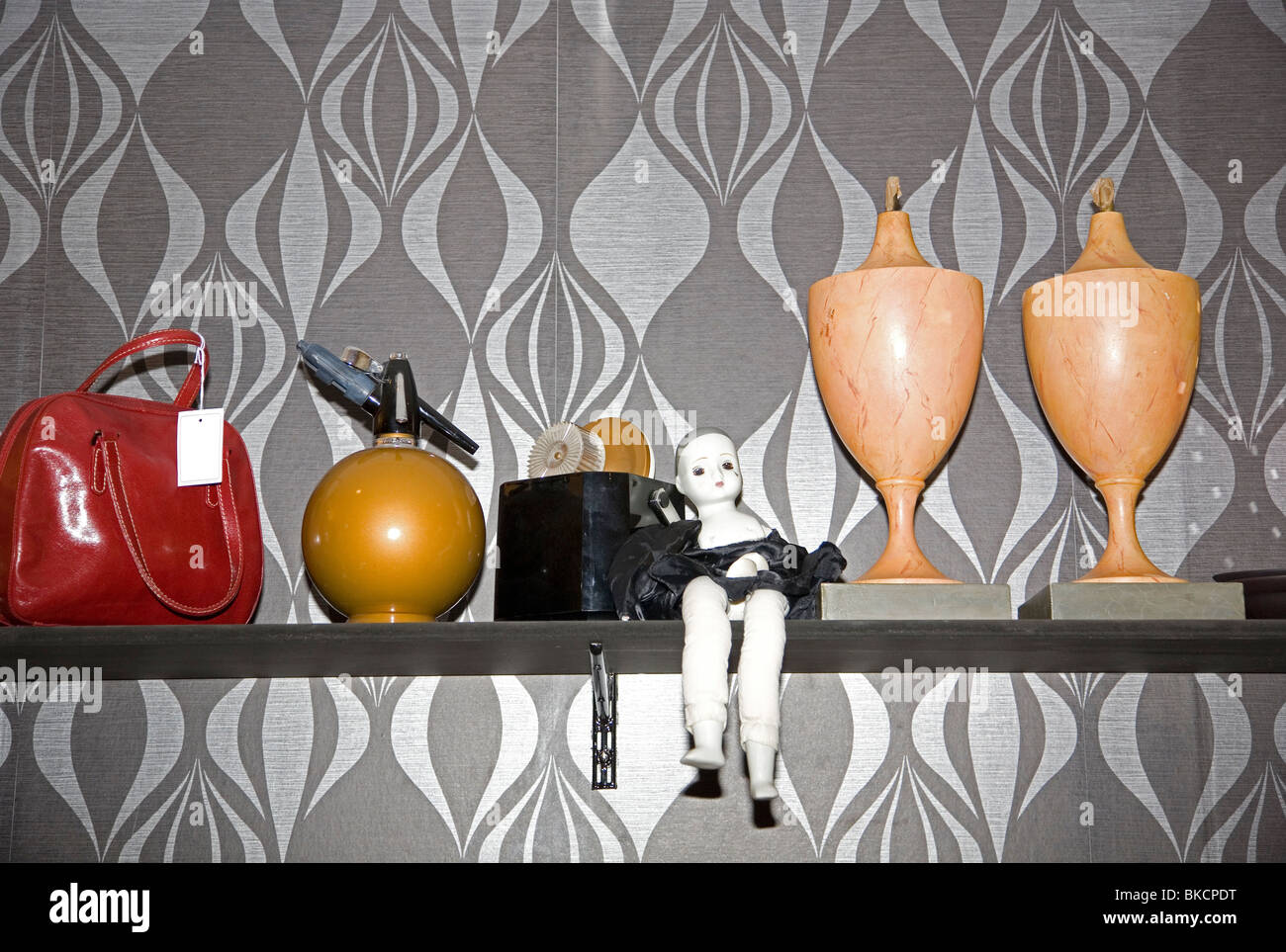Wall shelf in charity shop with ornaments Stock Photo - Alamy