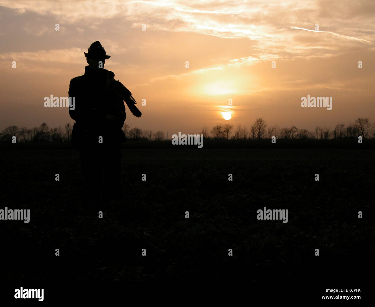 Hunters at sunset Stock Photo - Alamy