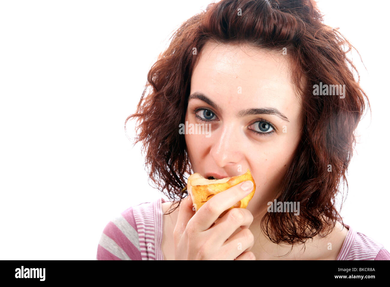Hungry woman eating a pear Stock Photo - Alamy