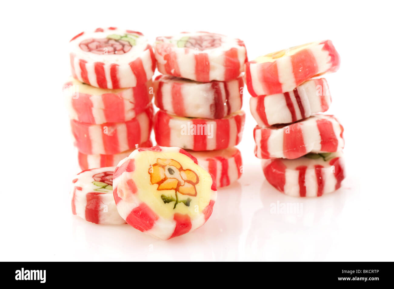 Many old fashioned sweets in red stacked on white background Stock ...